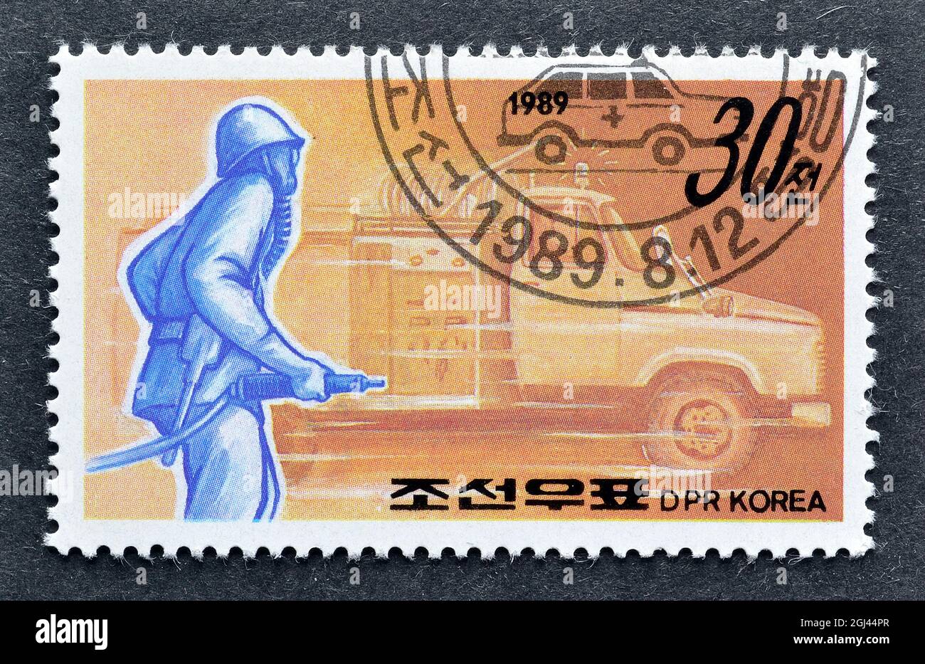 Cancelled postage stamp printed by North Korea, that shows Fireman and ...
