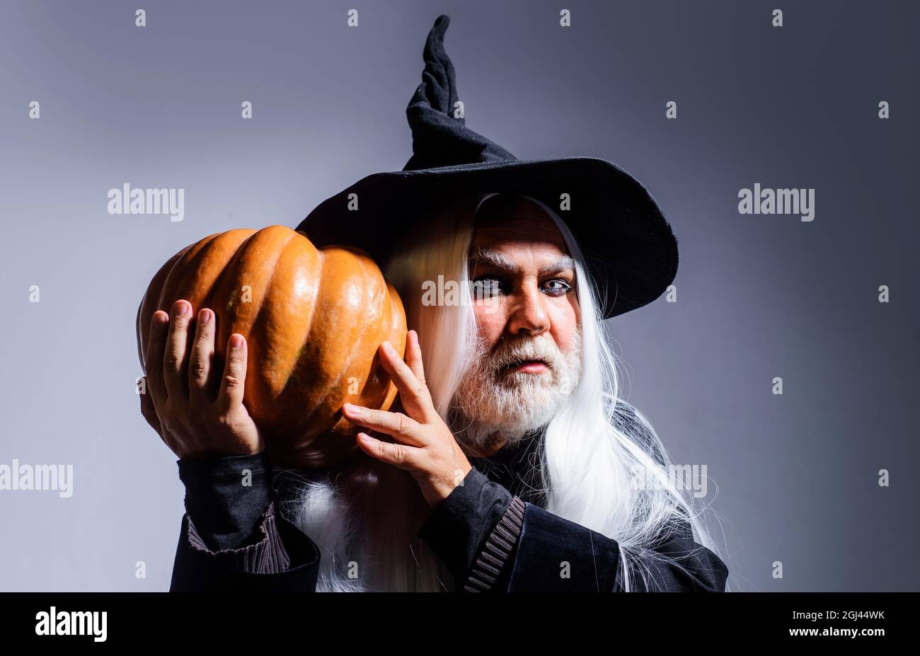 Man in witch hat with pumpkin. Scary Halloween. Devil with Jack o ...