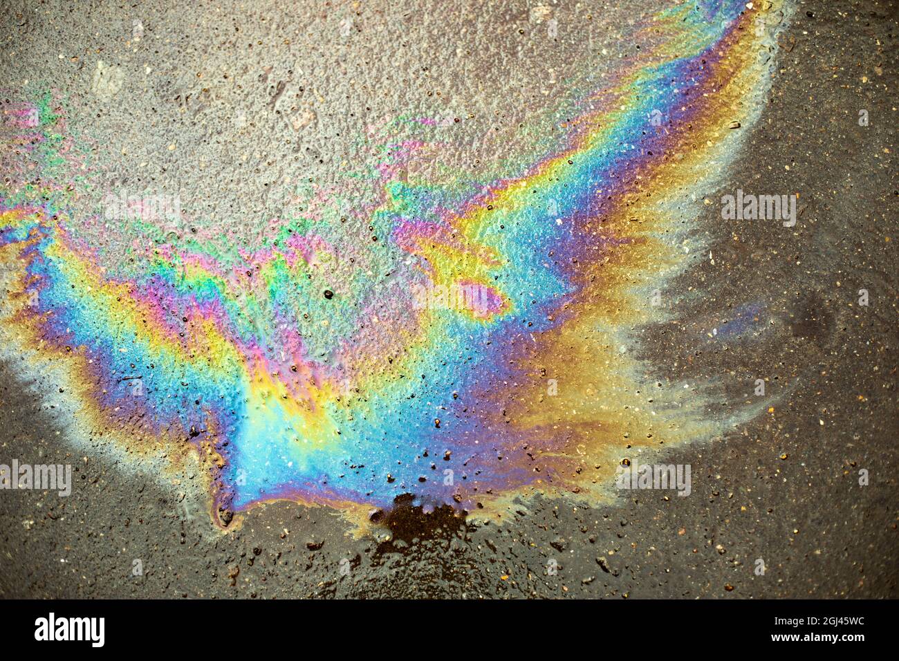 Gasoline stain on the asphalt. Fuel texture. Rainbow spot of ...