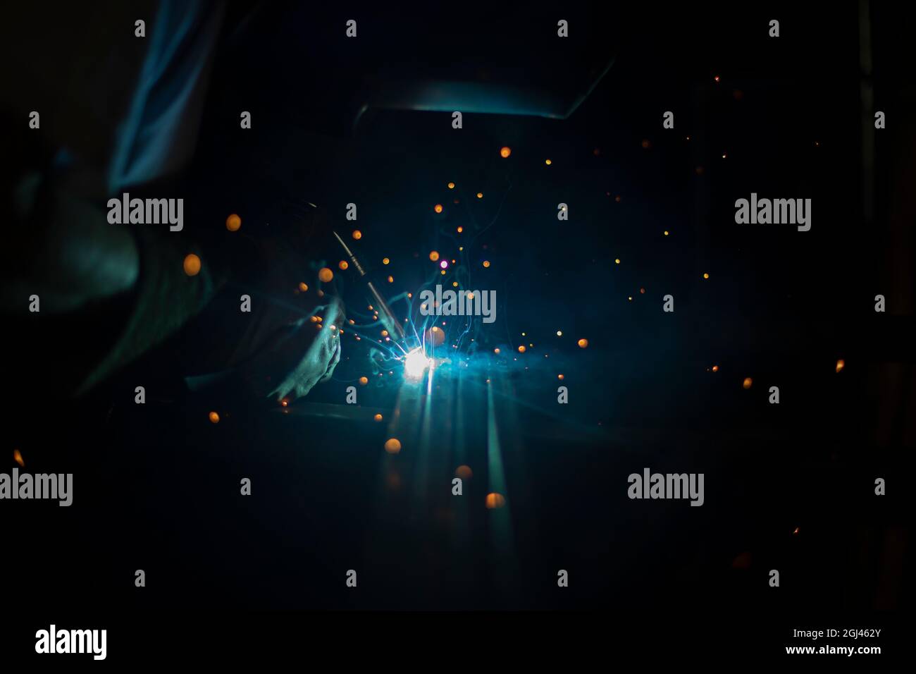 Fire from metal welding. Sparks in the dark when working with a red-hot ...