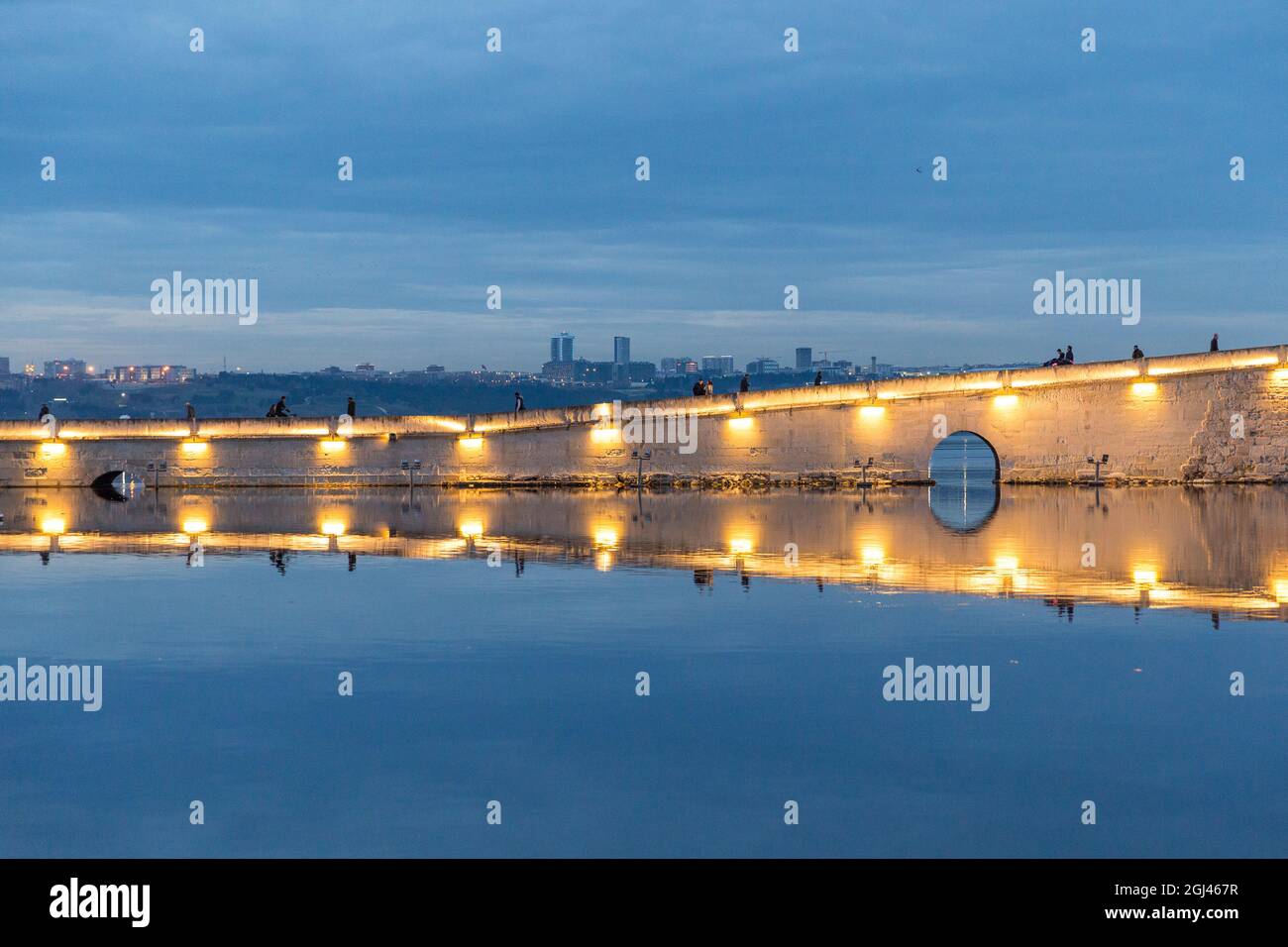 People on the historical Mimar Sinan Bridge in Kucukcekmece lake in ...