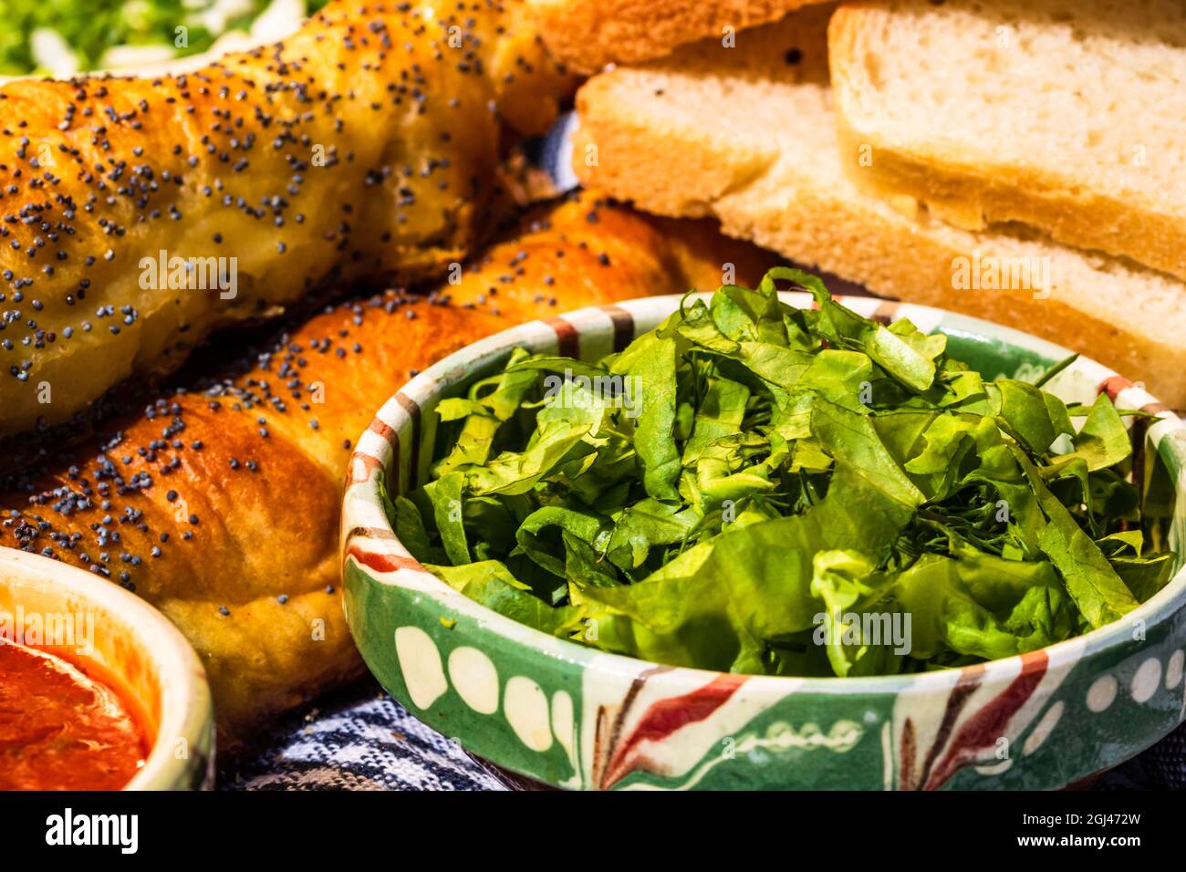 Bowl of lettuce, breads, and tomato sauce on a table Stock Photo - Alamy