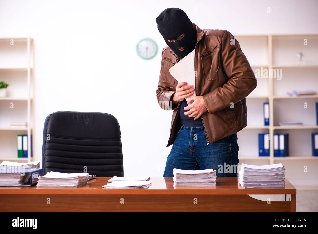 Young man in balaclava in industrial espionage concept Stock Photo - Alamy