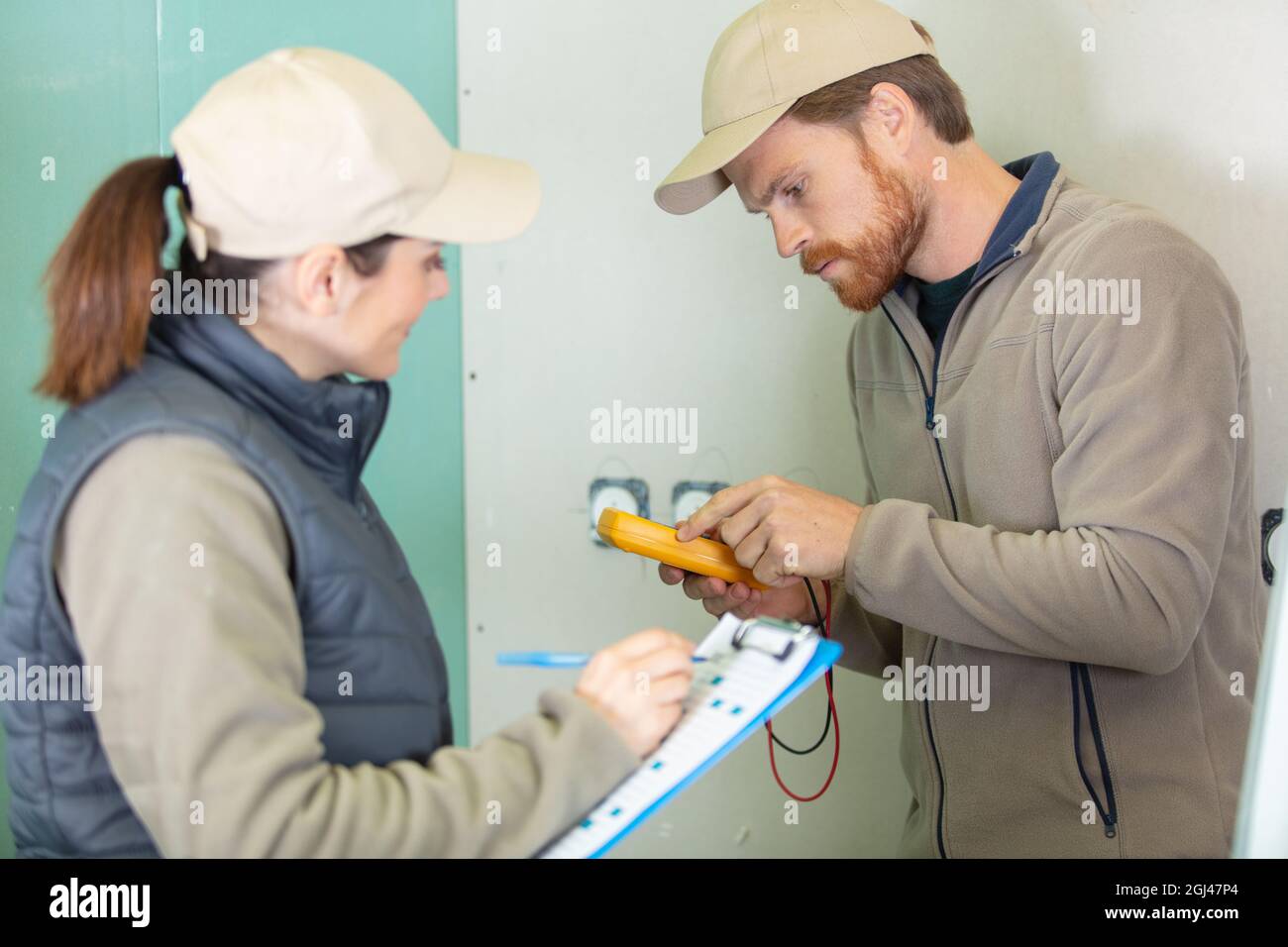 two builders working on building project Stock Photo - Alamy