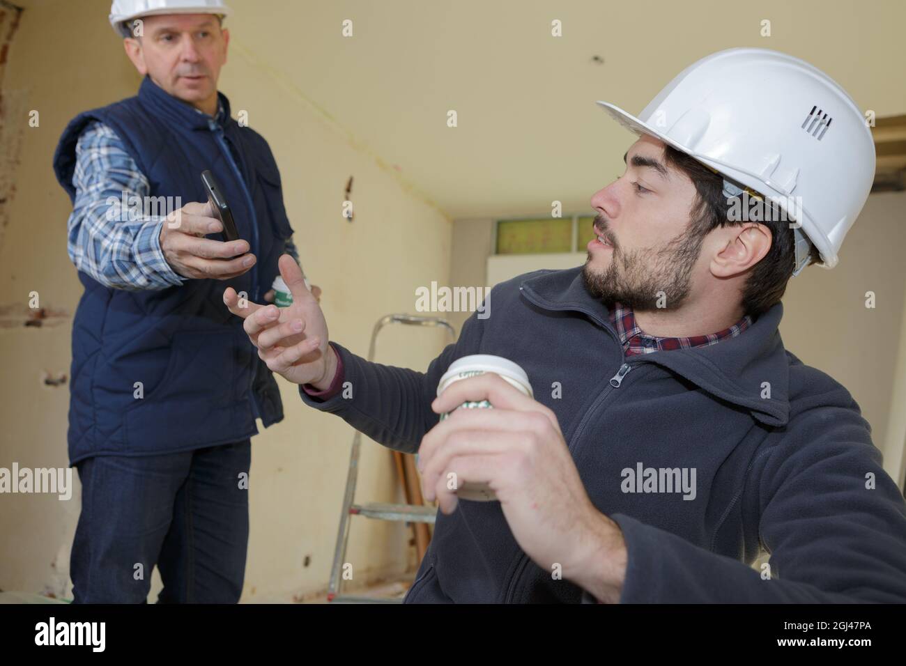Professionals discussing construction hi-res stock photography and ...