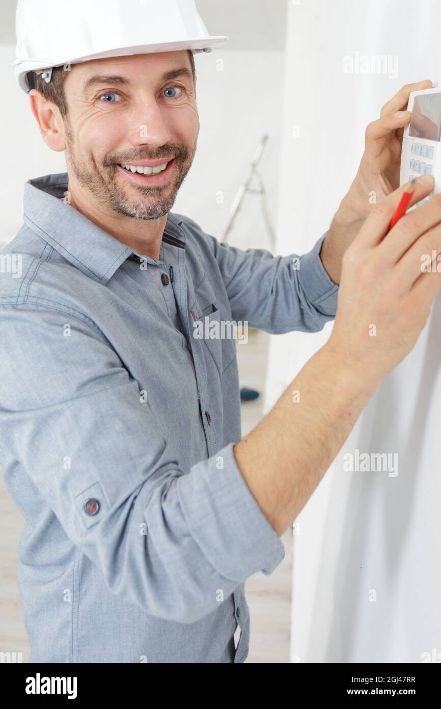 man adjusting air conditioning system Stock Photo - Alamy