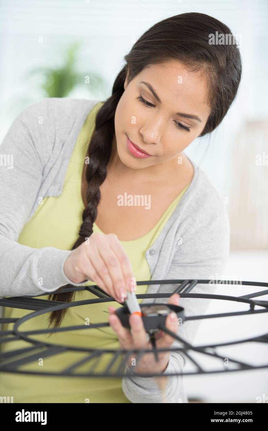 a woman is changing the time of a clock Stock Photo - Alamy