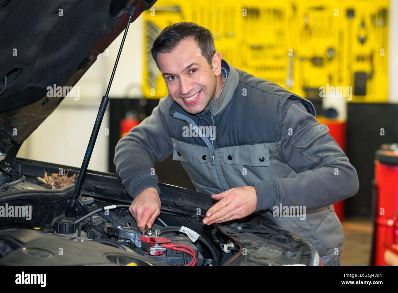 professional car mechanic smiling to the camera while working Stock ...