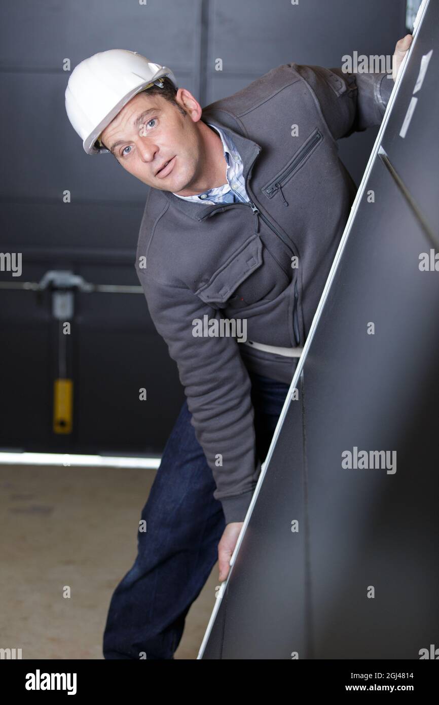 factory man worker moving metal sheet in workshop Stock Photo - Alamy
