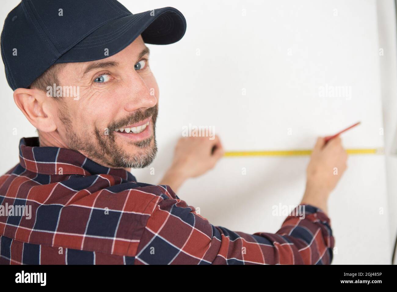 close up hand measuring wall meter distance Stock Photo - Alamy