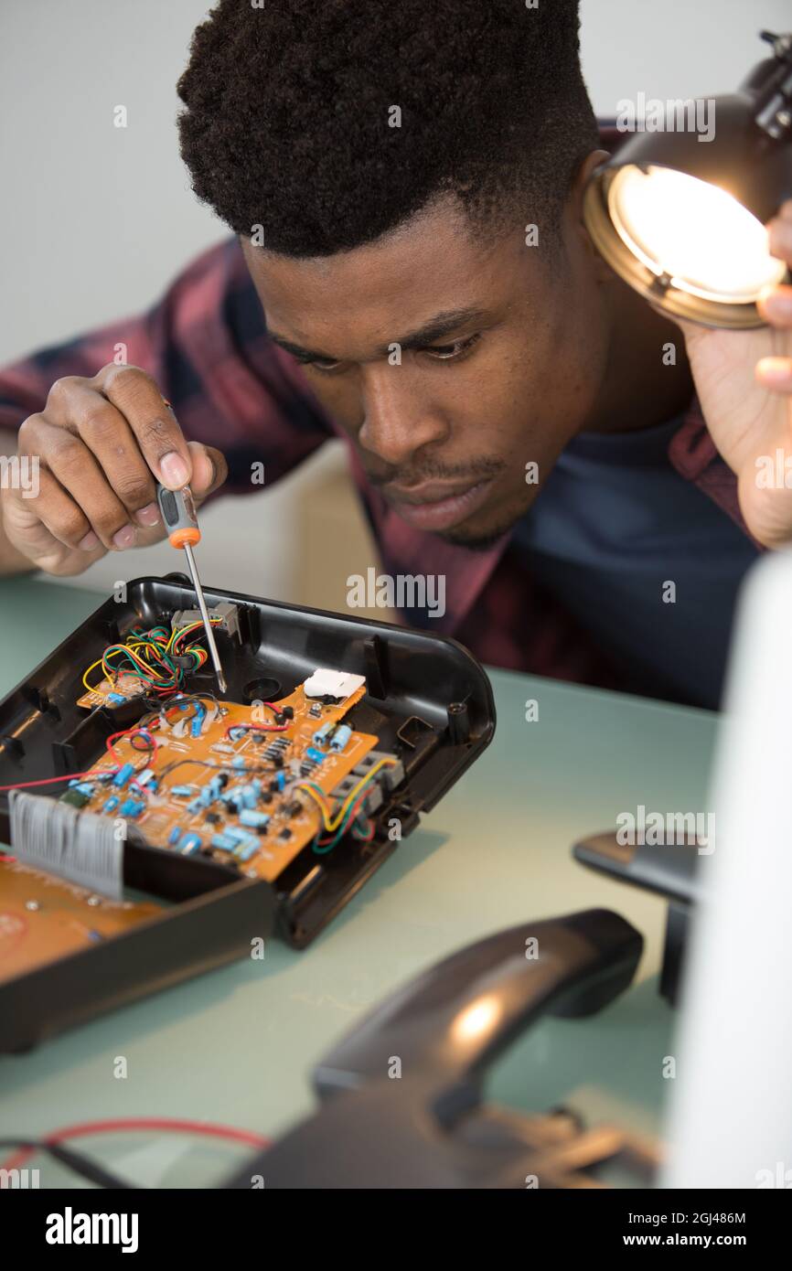 engineer uses tool for repair electronic devices Stock Photo - Alamy