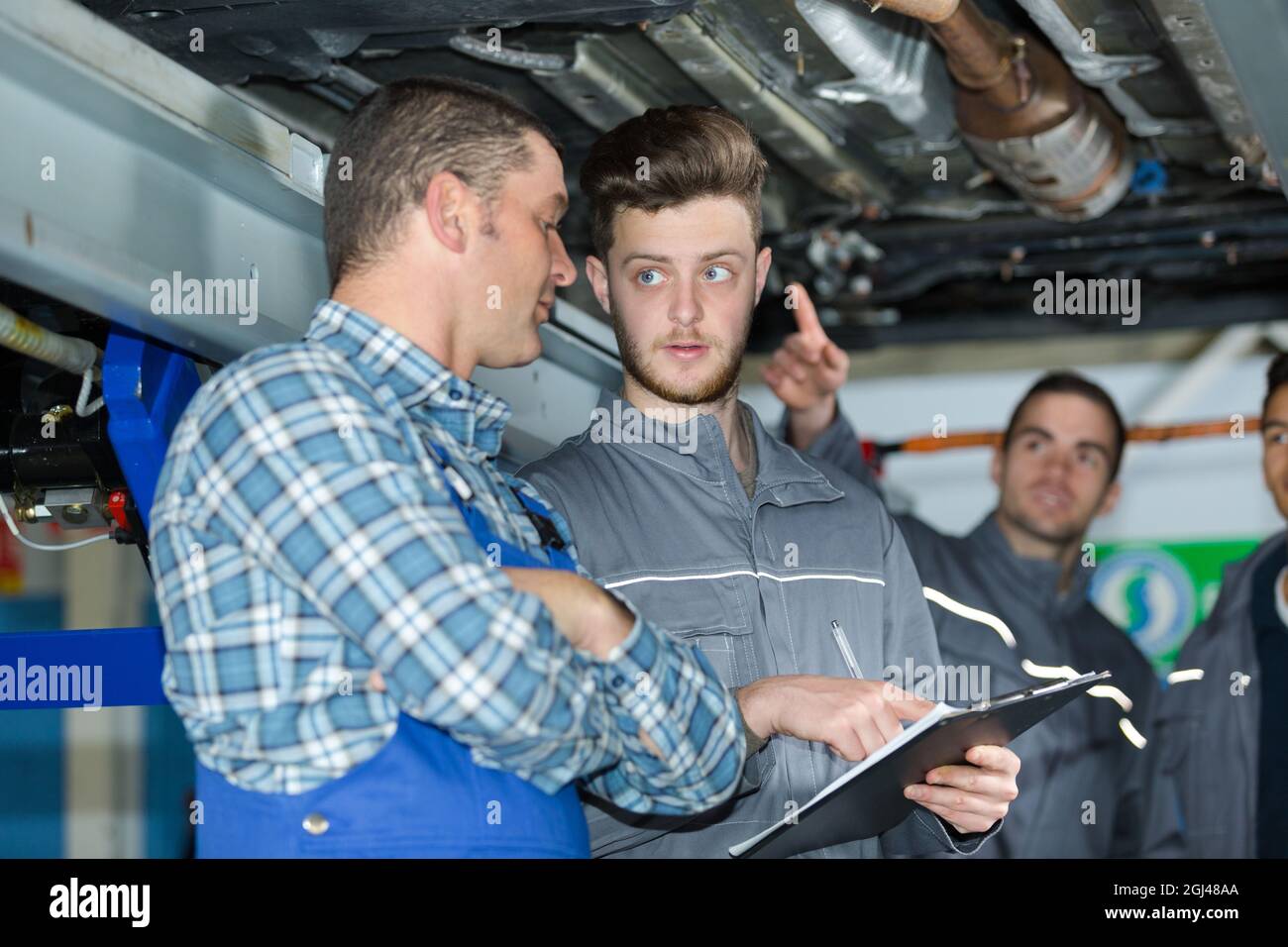 mechanic and apprentice in factory Stock Photo - Alamy