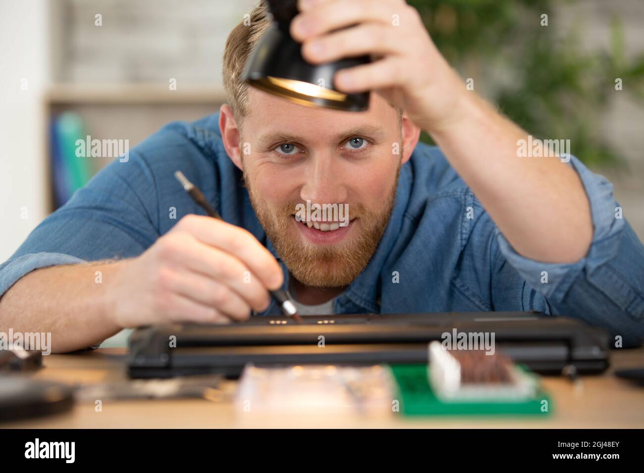 Male tech repairs electronic equipment hi-res stock photography and ...