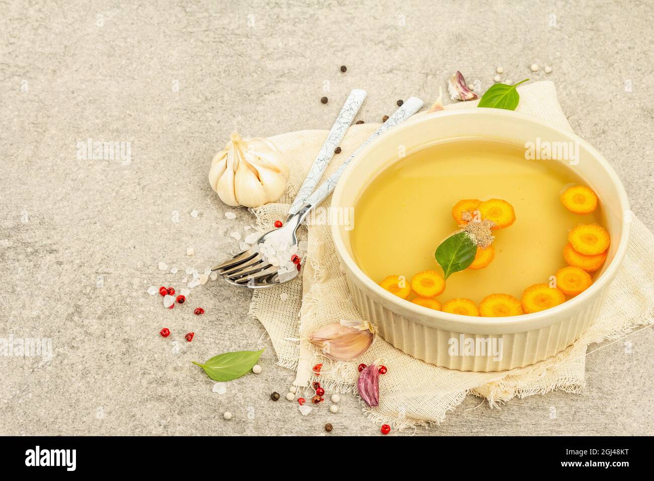 Transparent chicken broth with vegetables and spices. Traditional ...
