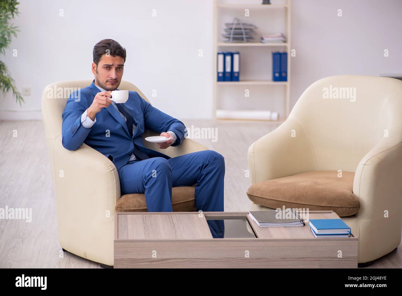 Young businessman employee waiting for business meeting Stock Photo - Alamy