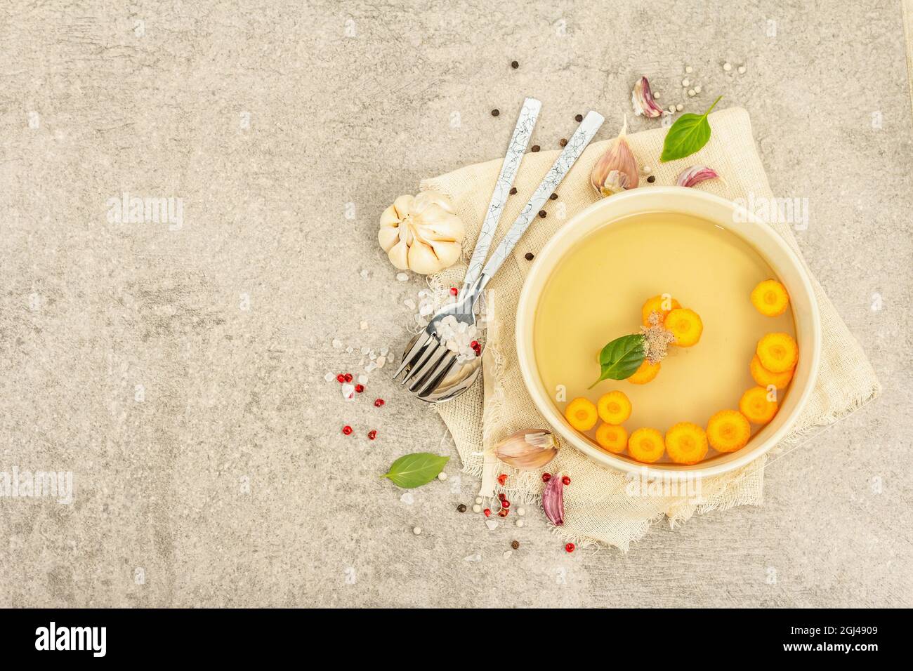 Transparent chicken broth with vegetables and spices. Traditional ...