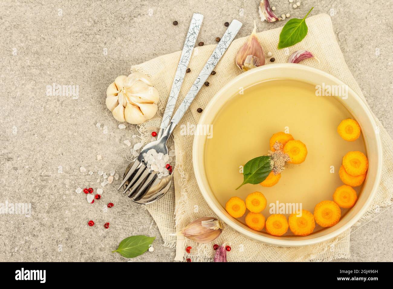 Transparent chicken broth with vegetables and spices. Traditional ...
