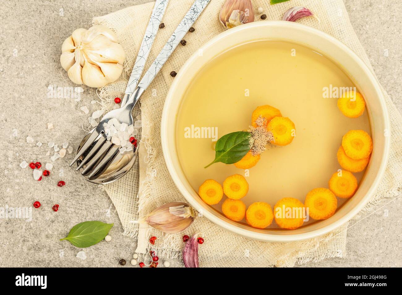 Transparent chicken broth with vegetables and spices. Traditional ...