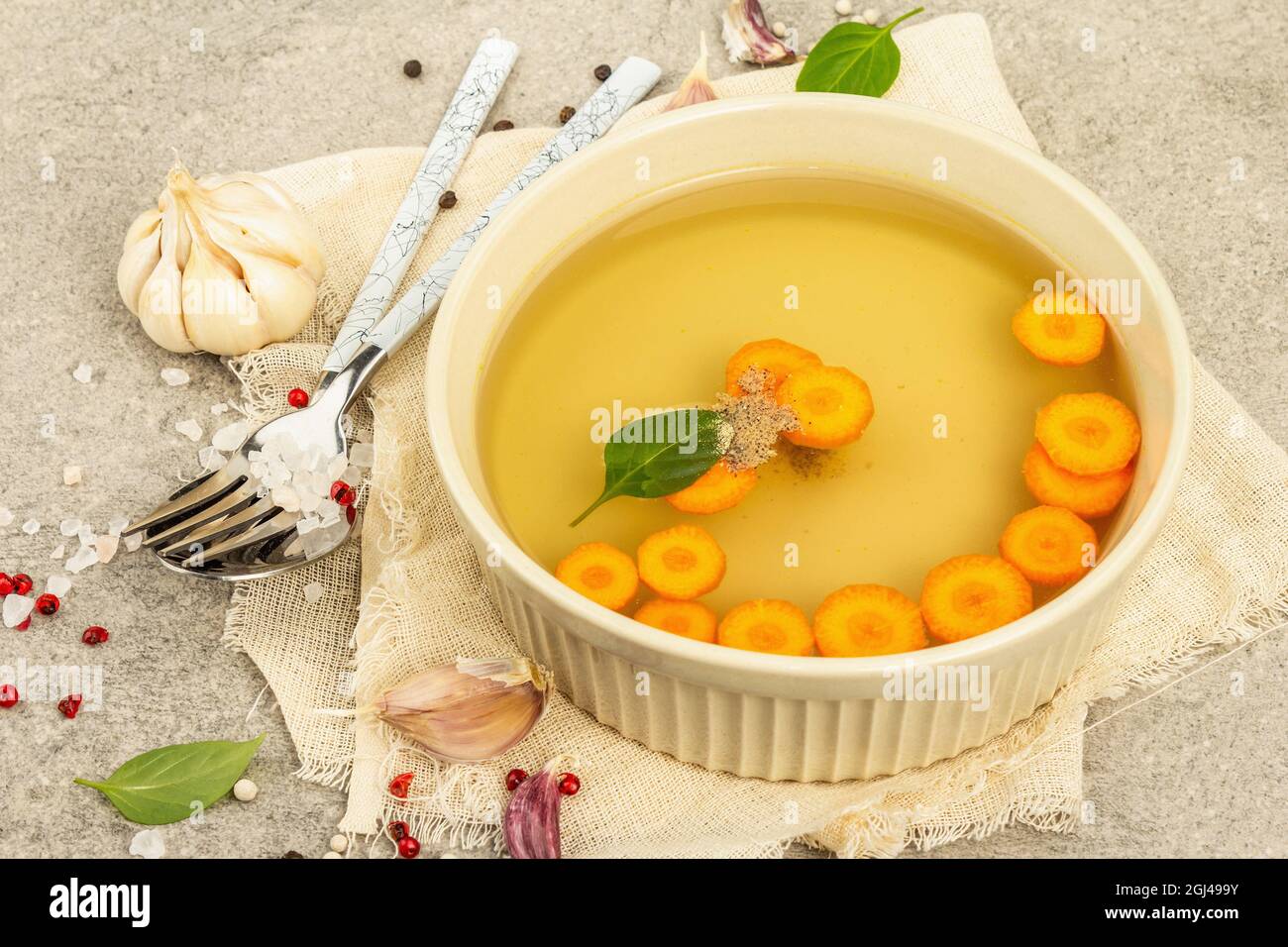 Transparent chicken broth with vegetables and spices. Traditional ...