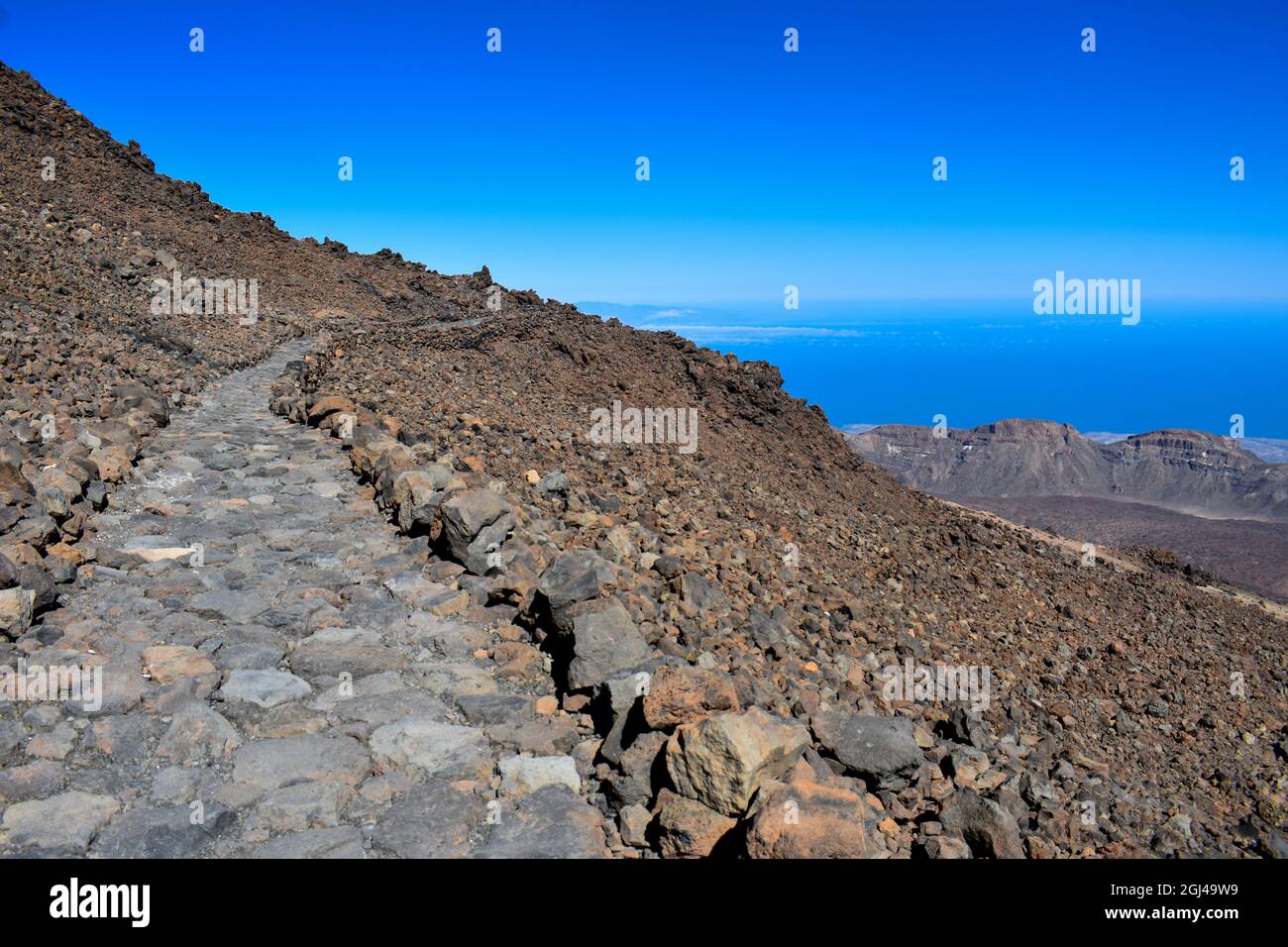 Closeup shot of a small rocky path on a hill with many stones and a ...