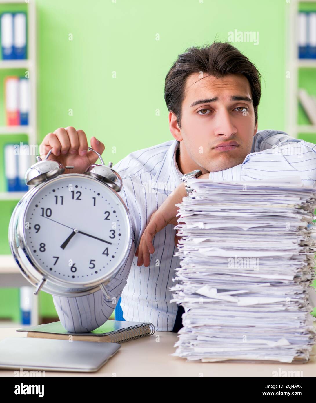 The businessman having problems with paperwork and workload Stock Photo ...