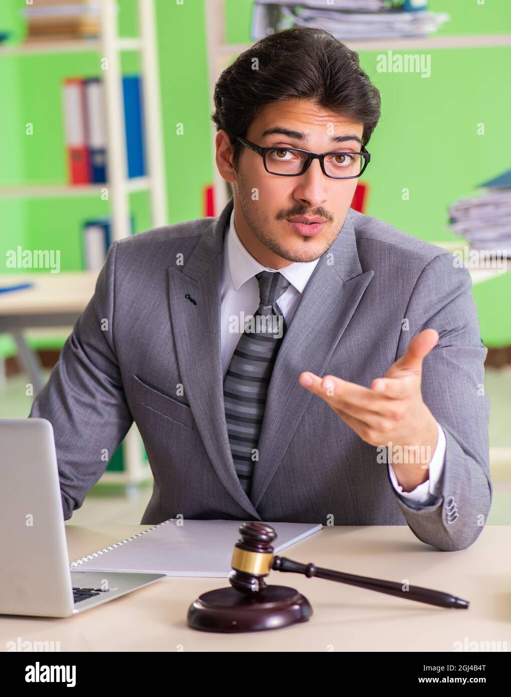 The young handsome lawyer working in the office Stock Photo - Alamy