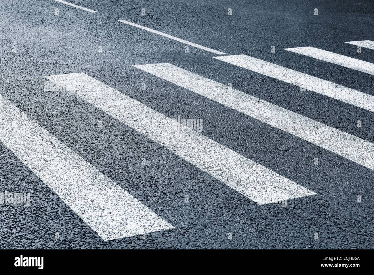 White lines on the city asphalt crossroad Stock Photo - Alamy