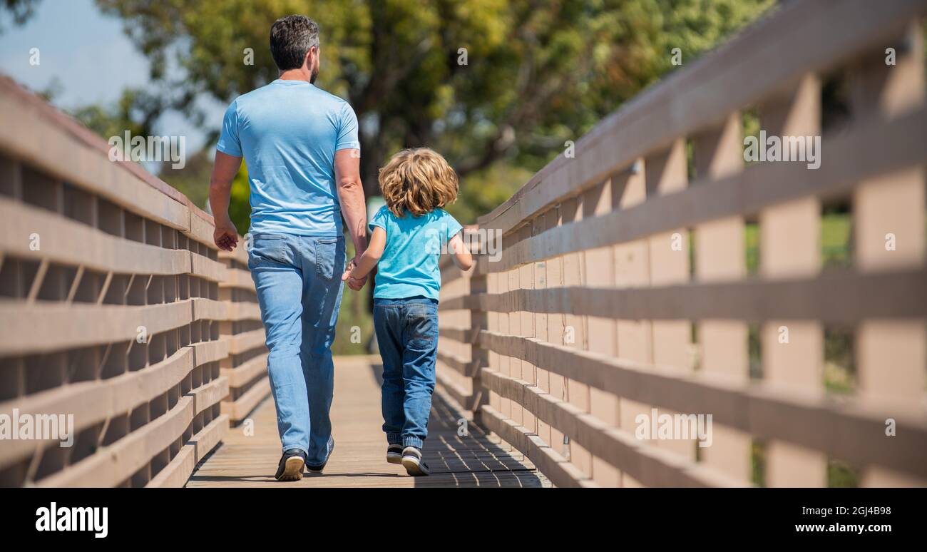 parenting and fatherhood. fathers day. happy father and son walking ...