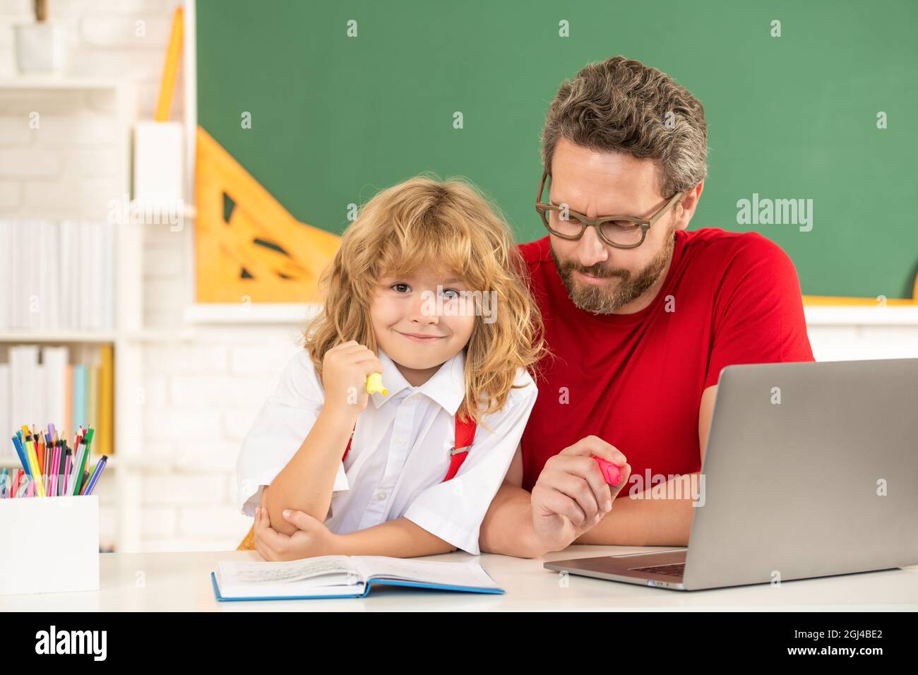 father and son study in classroom with laptop, school Stock Photo - Alamy