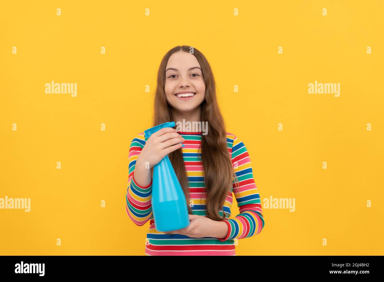 For all cleaning needs. Happy girl hold spraying bottle. Cleaning spray ...