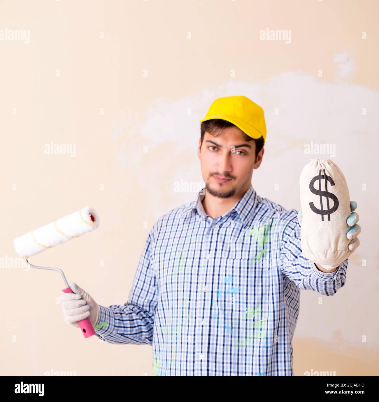 The painter man painting the wall at home Stock Photo - Alamy