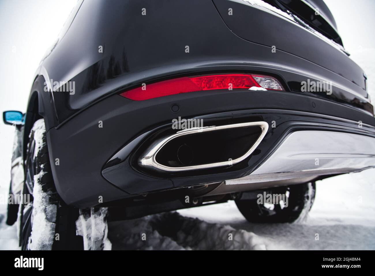 Car with winter tires on light-alloy wheels on snow at shallow depth of ...