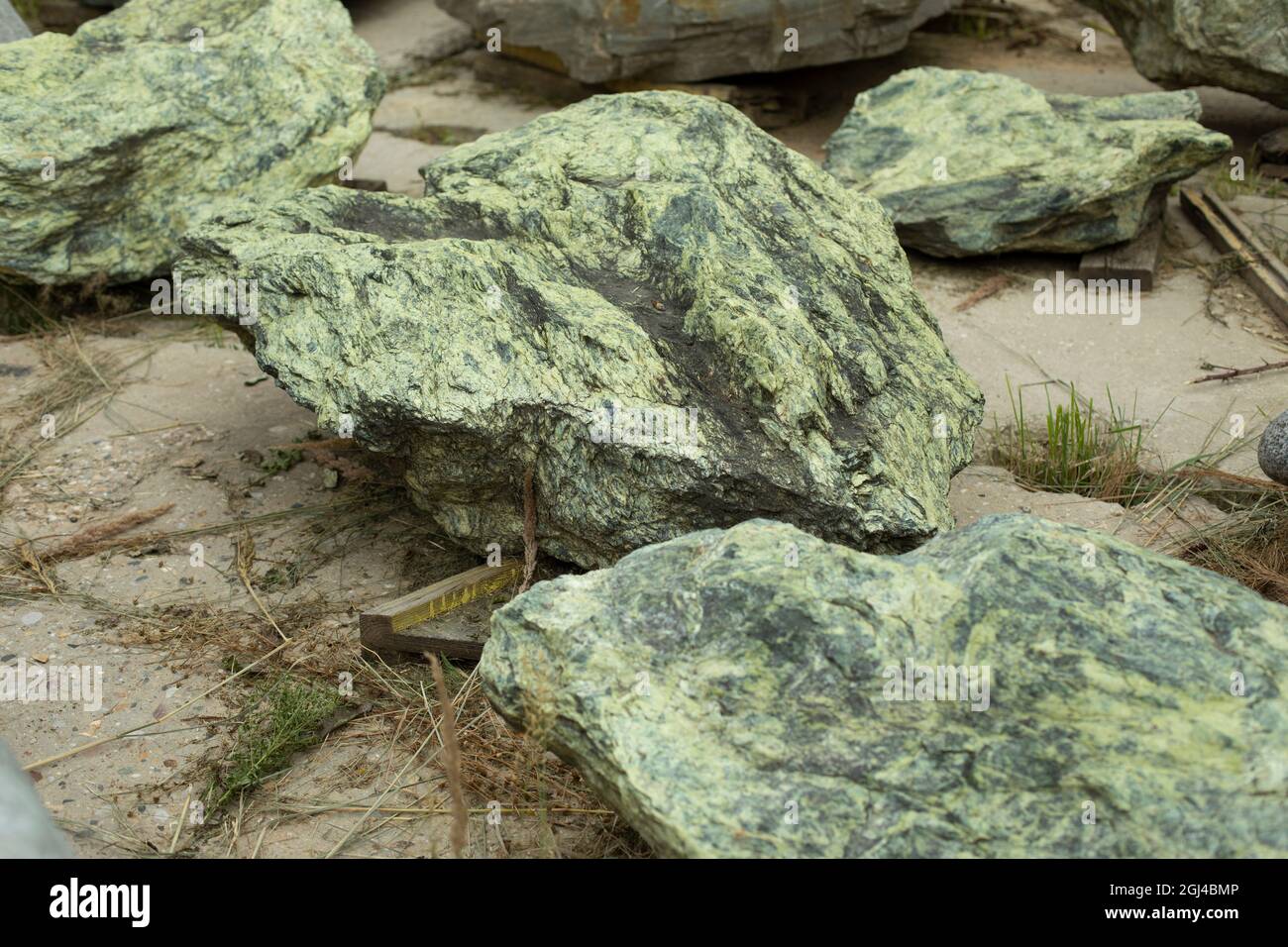 The stone is green. A piece of rock in the park. Rock. Stone for ...