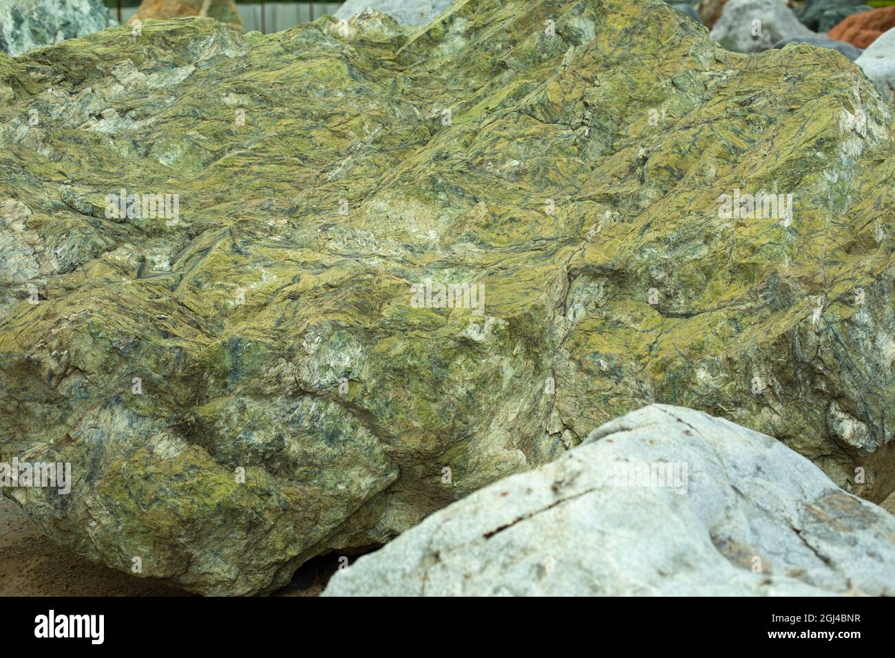 The stone is green. A piece of rock in the park. Rock. Stone for ...