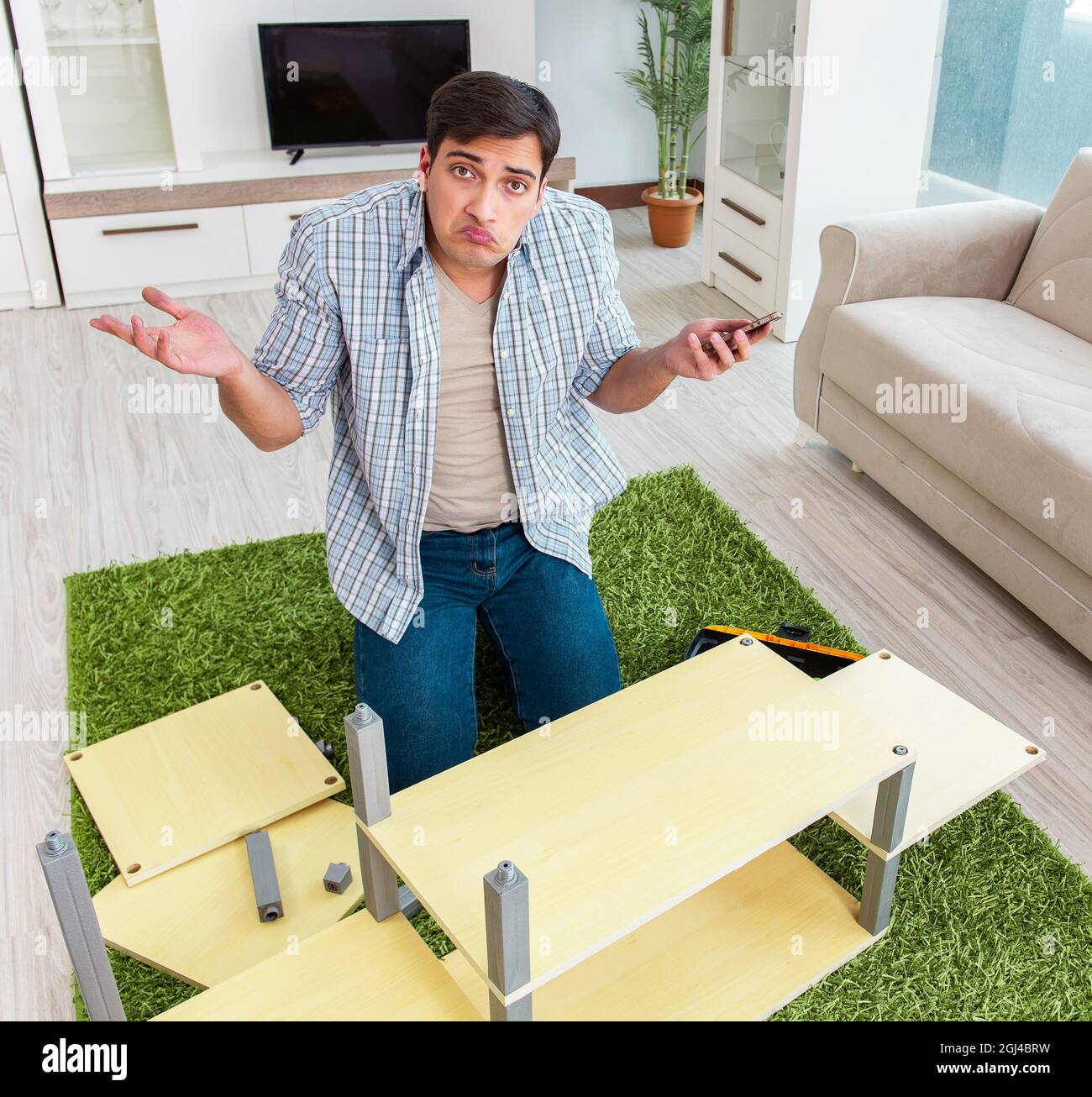 The man assembling furniture at home Stock Photo - Alamy