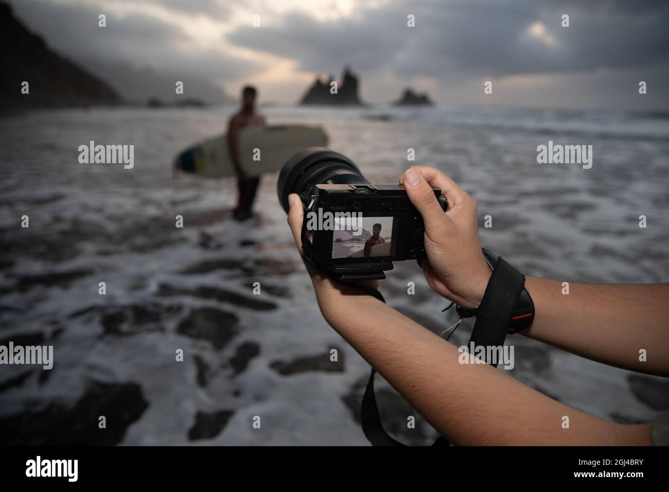 Close-up of the hands of a photographer holding his camera during a ...
