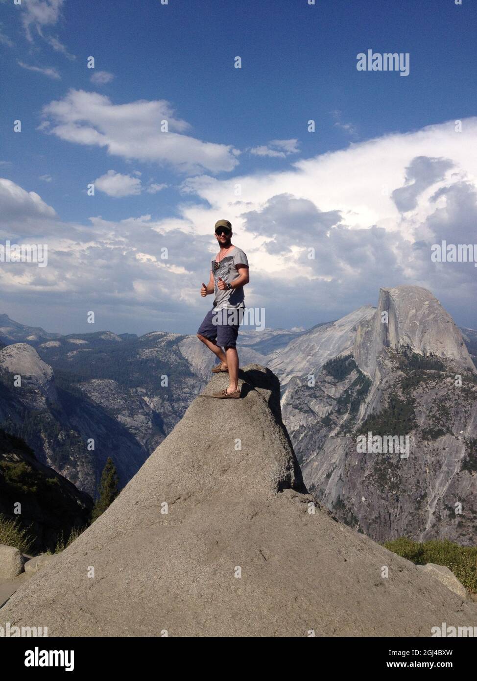 Male hiker having fun on the peak of a mountain Stock Photo - Alamy