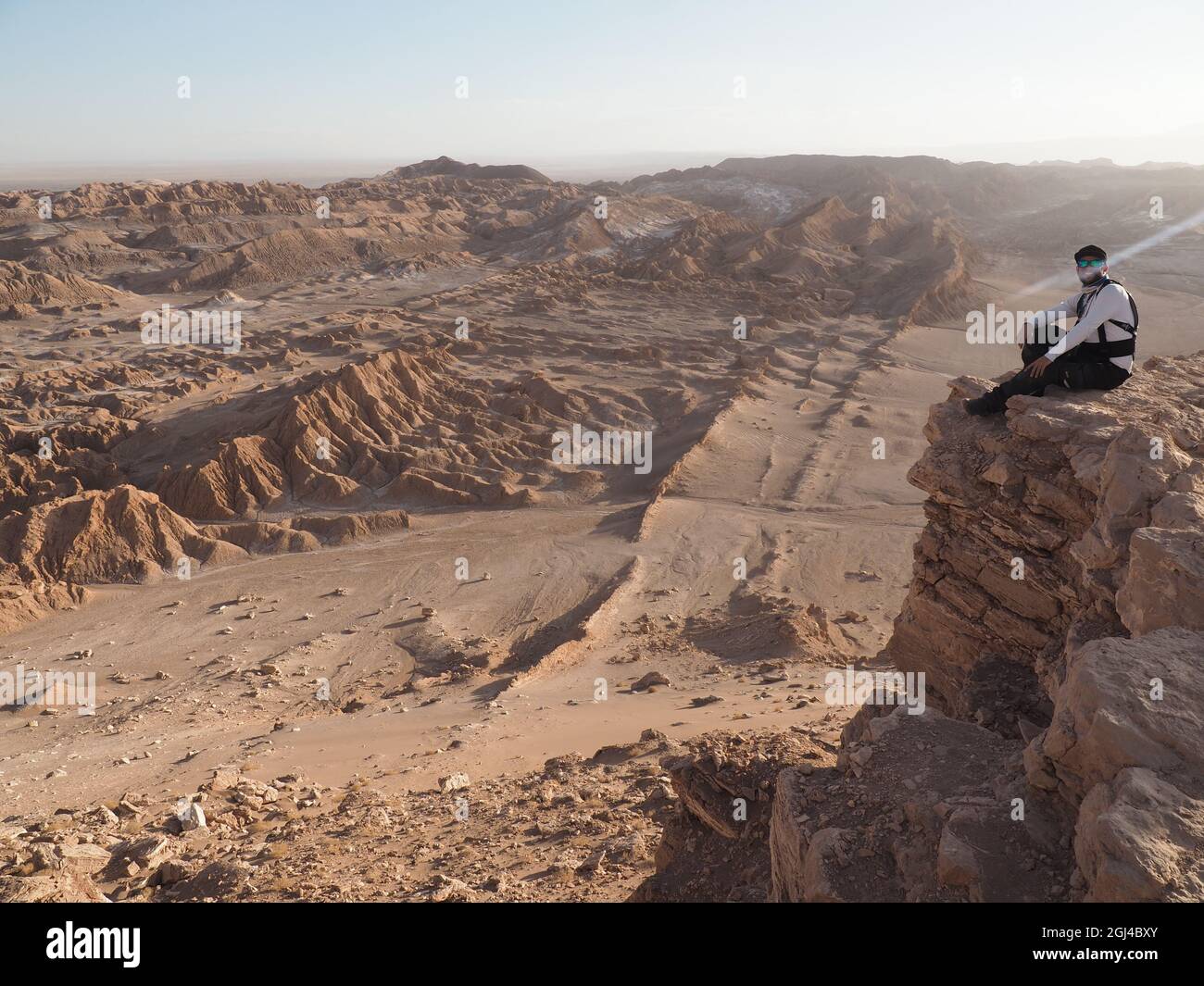 Male hiker resting and enjoying the view on a dry cliff Stock Photo - Alamy