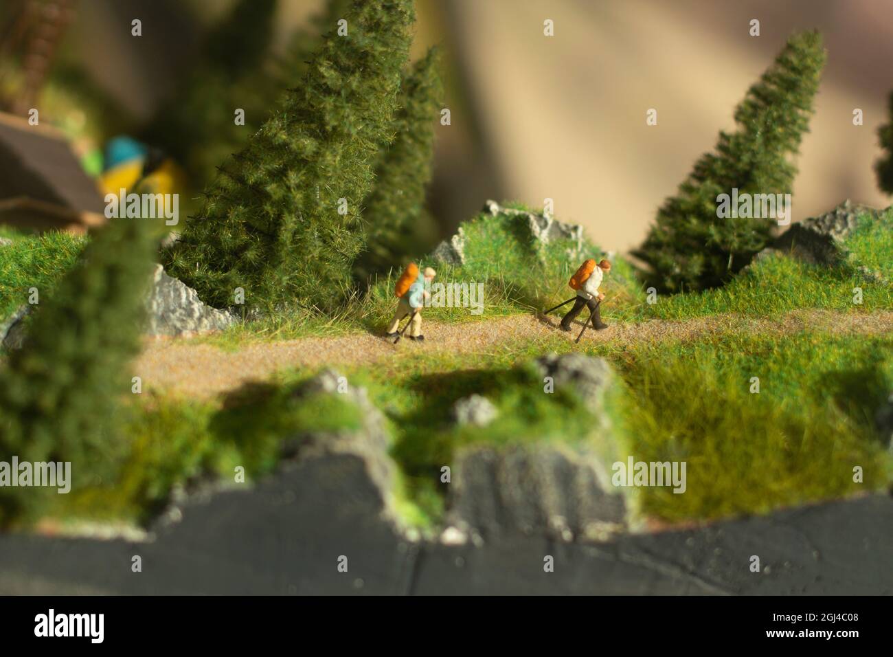Miniature model of tourists on a mountain trail. Figures of people ...