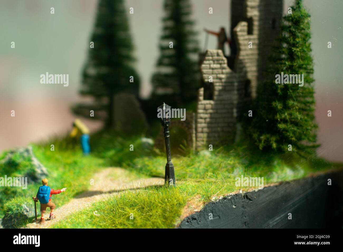 Miniature model of tourists on a mountain trail. Figures of people ...