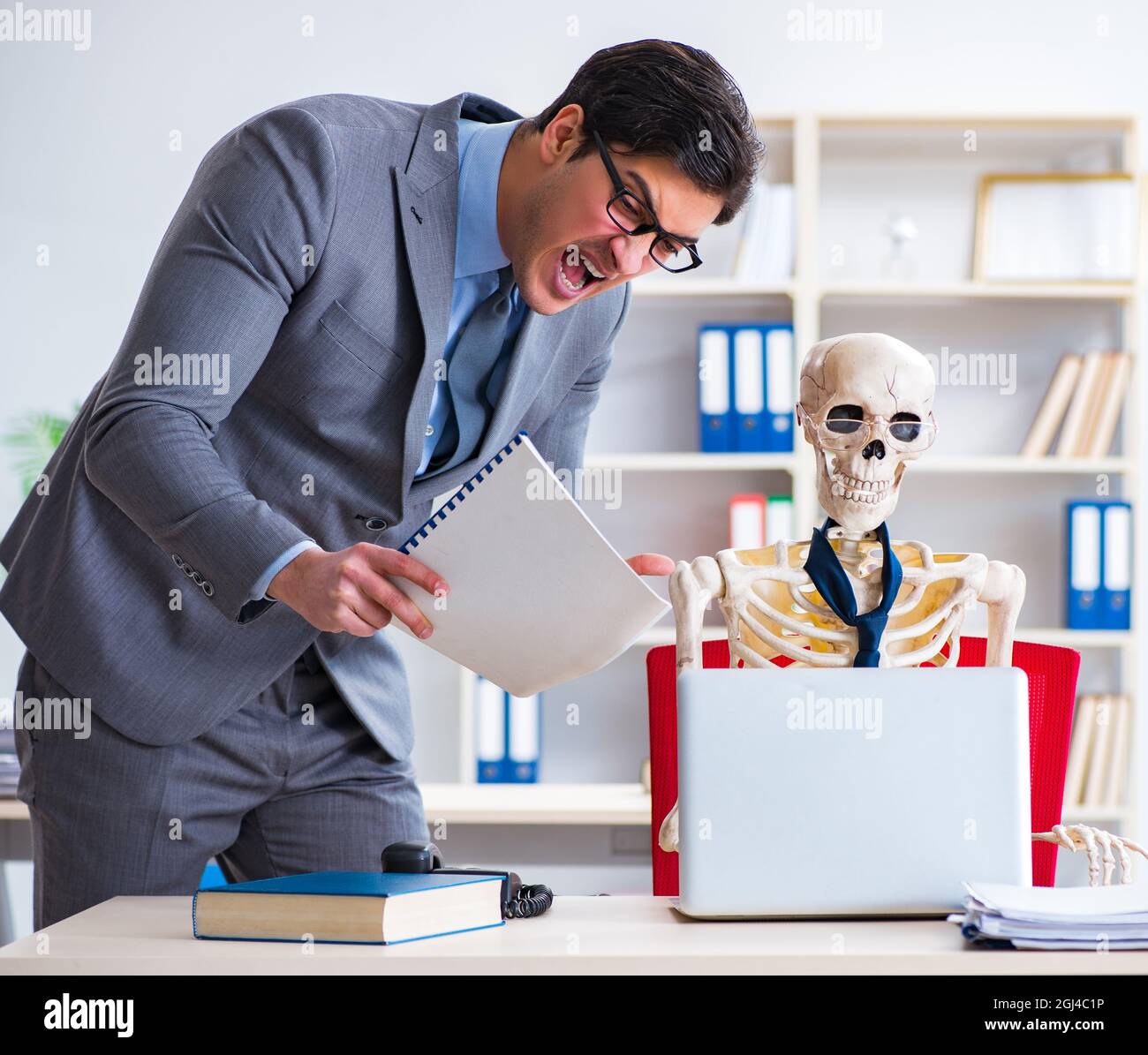The angry boss yelling at his skeleton employee Stock Photo - Alamy