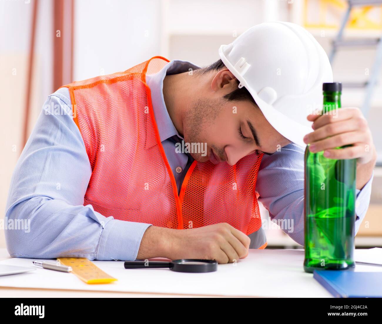 The drunk engineer working in the workshop Stock Photo - Alamy