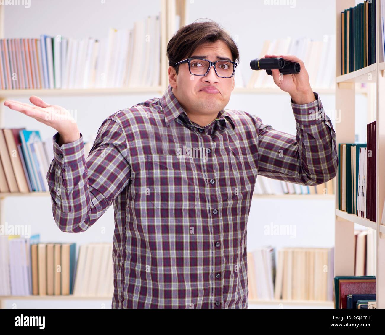 The young student looking for books in college library Stock Photo - Alamy