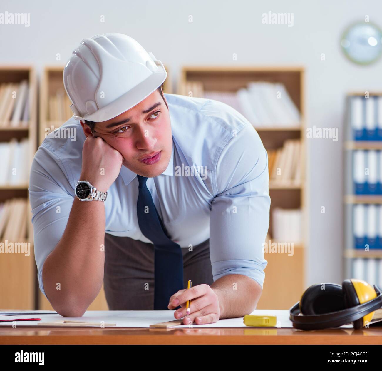 The engineer supervisor working on drawings in the office Stock Photo ...