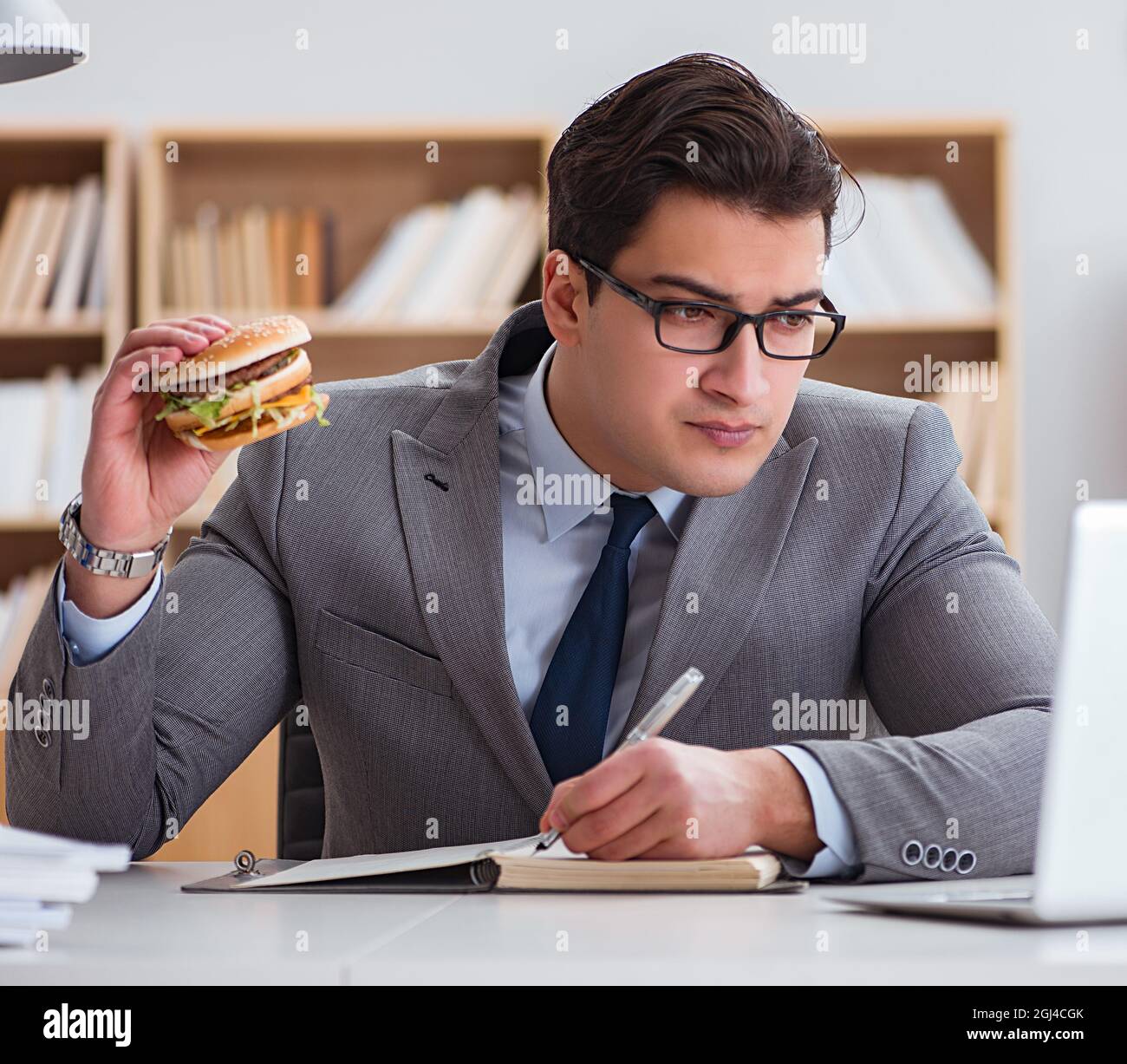 Hungry businessman manager eating sandwich hi-res stock photography and ...