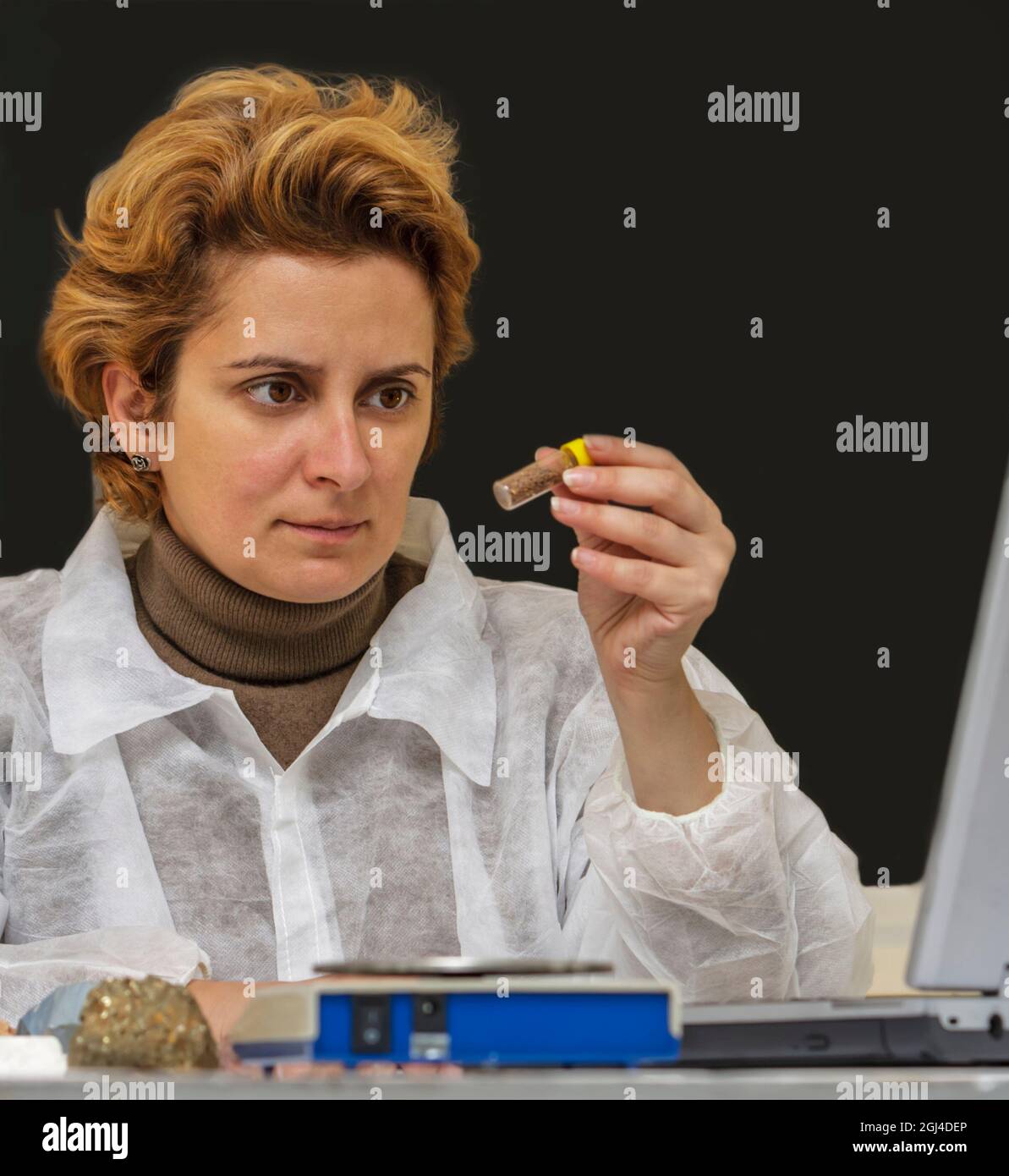 Female geologist researcher analysing a rock at her workplace Stock ...