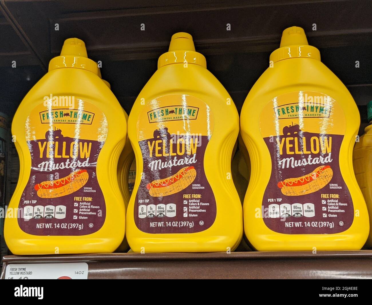 Various mustard bottles available for purchase in a market Stock Photo ...