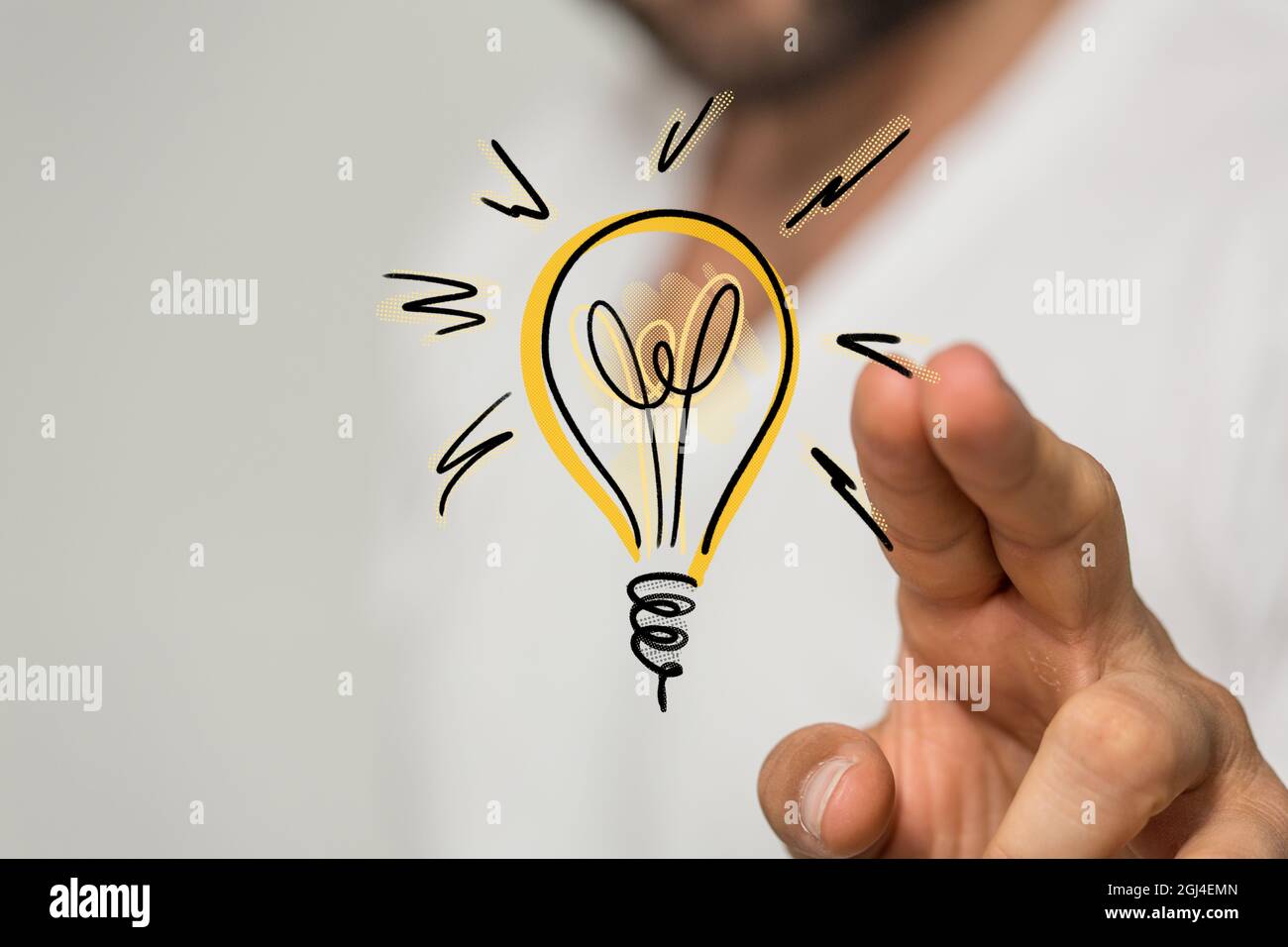 Male's hand pointing to an illustration of a light bulb Stock Photo - Alamy