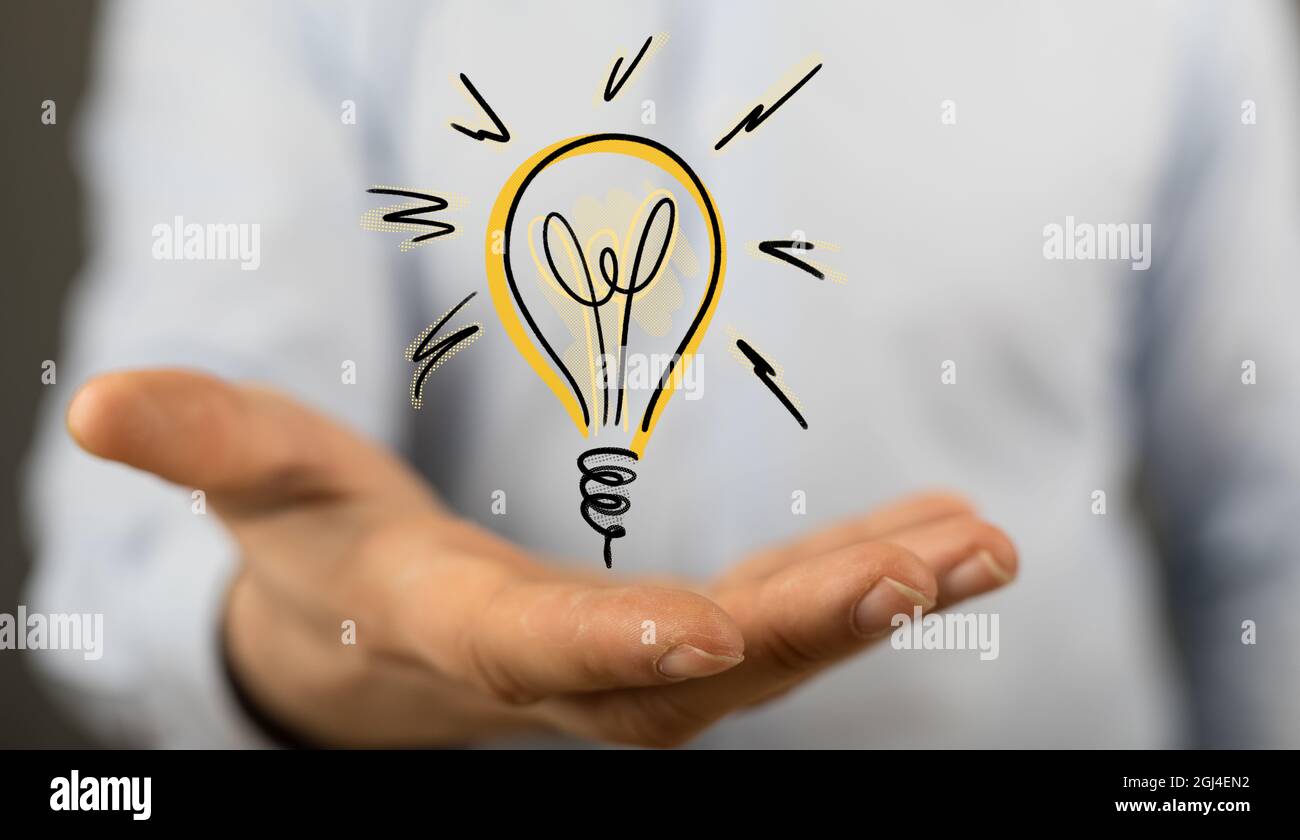 Male's hand pointing to an illustration of a light bulb Stock Photo - Alamy