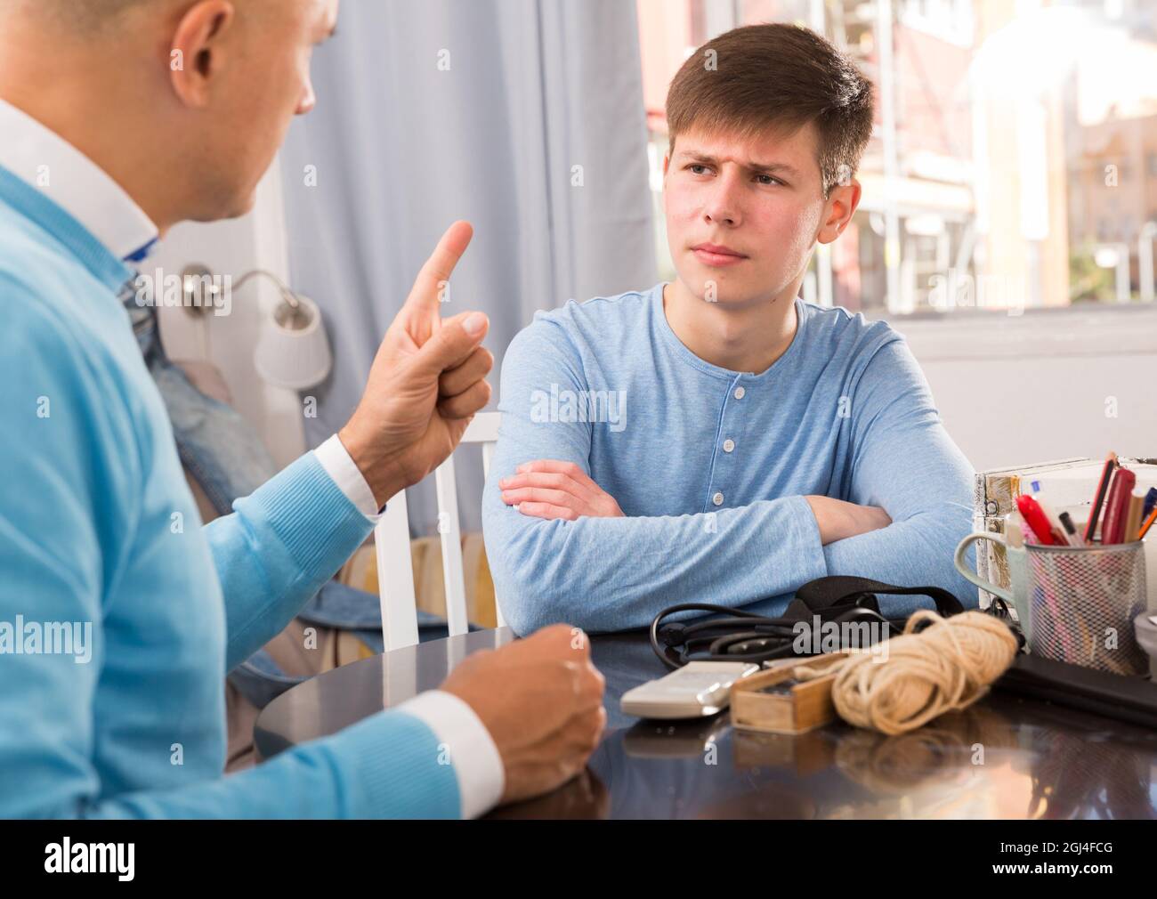 Teenager listening to reprimanding father Stock Photo - Alamy